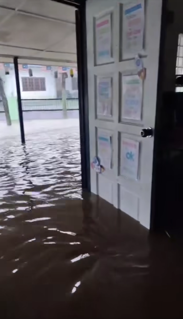 Kindergarten students stand on desks after being trapped by flood in M'sia