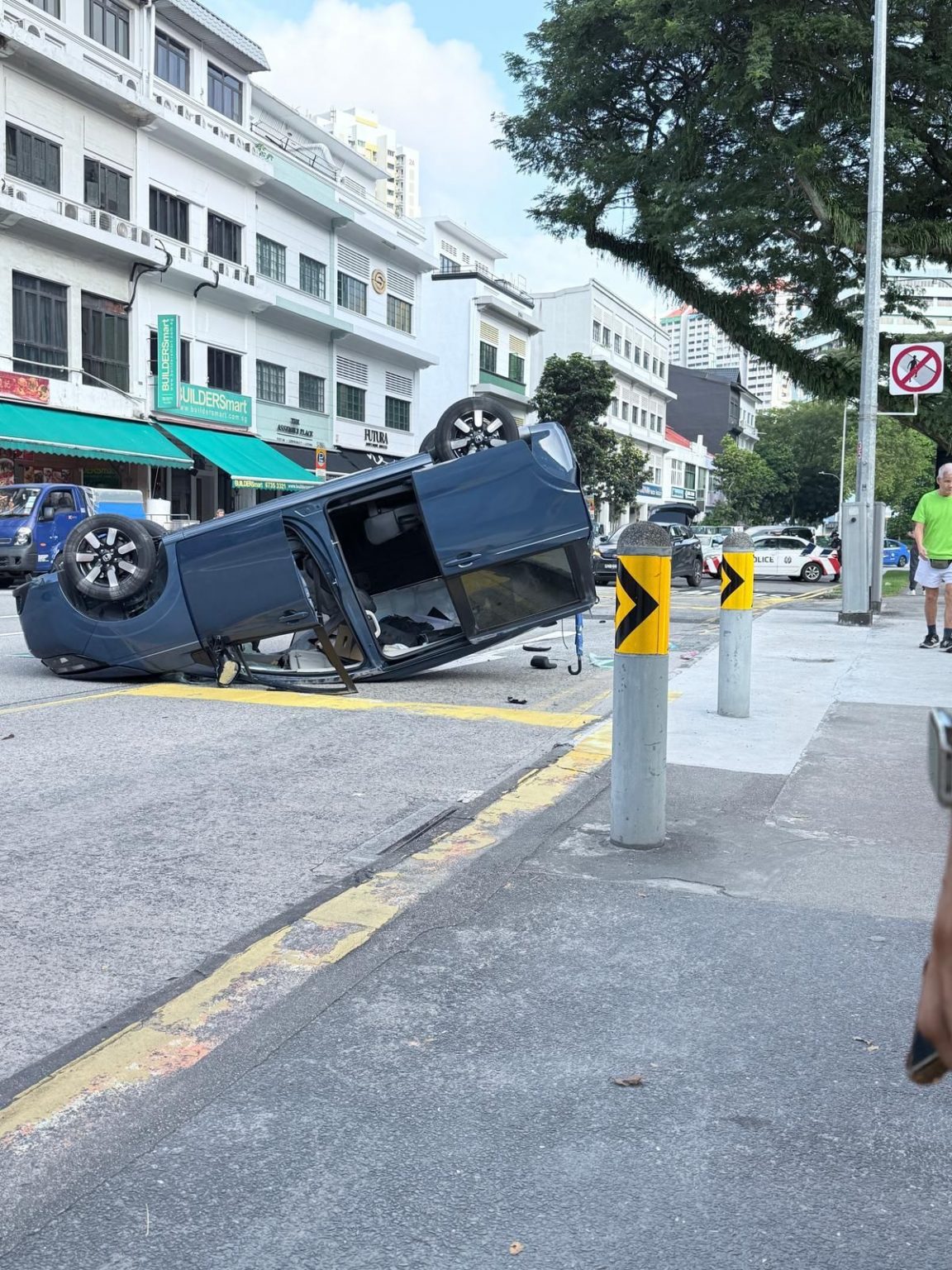 Car flips over along Outram Road, 61-year-old driver sent to the hospital