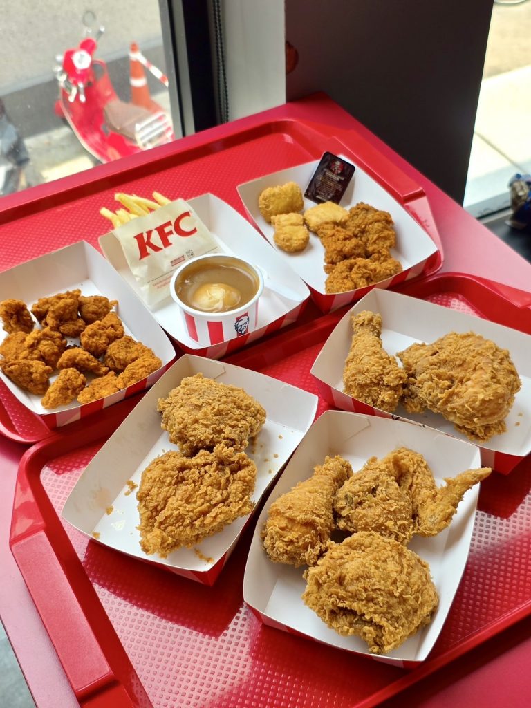 KFC Thailand urges customers to eat with hands, with signs next to ...